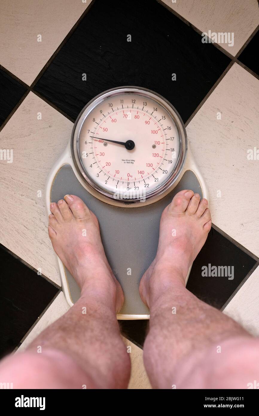 Male feet on scales hi-res stock photography and images - Alamy