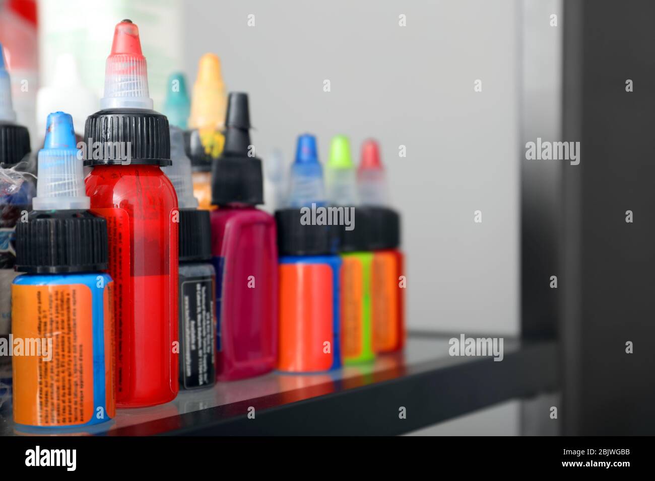 Many bottles with ink in tattoo salon Stock Photo - Alamy