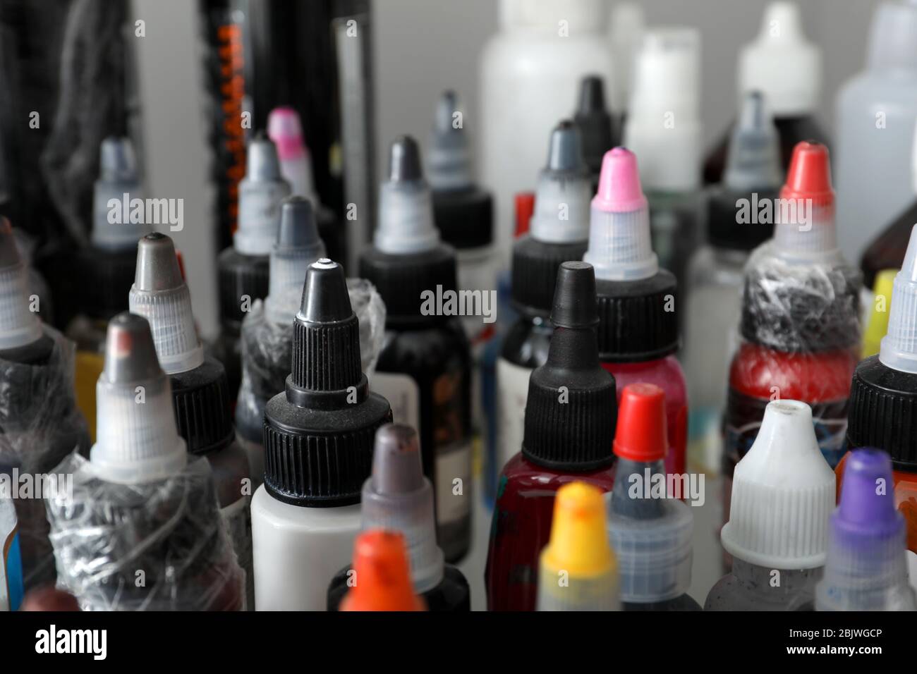 Many bottles with ink in tattoo salon Stock Photo - Alamy