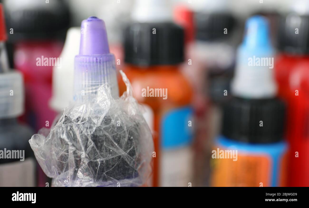 Bottle with ink in tattoo salon, closeup Stock Photo - Alamy