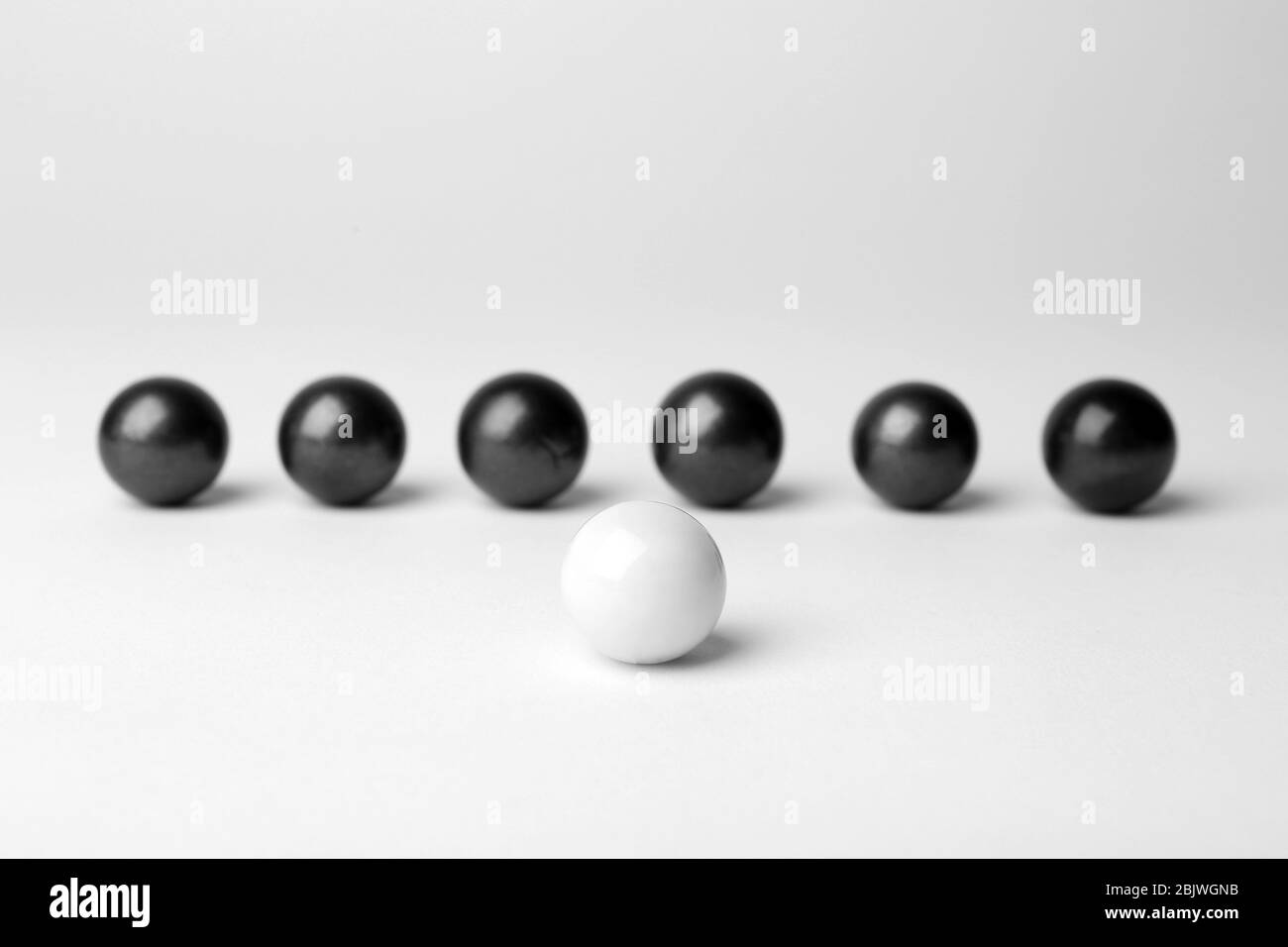 Decorative balls and one different on white background Stock Photo - Alamy