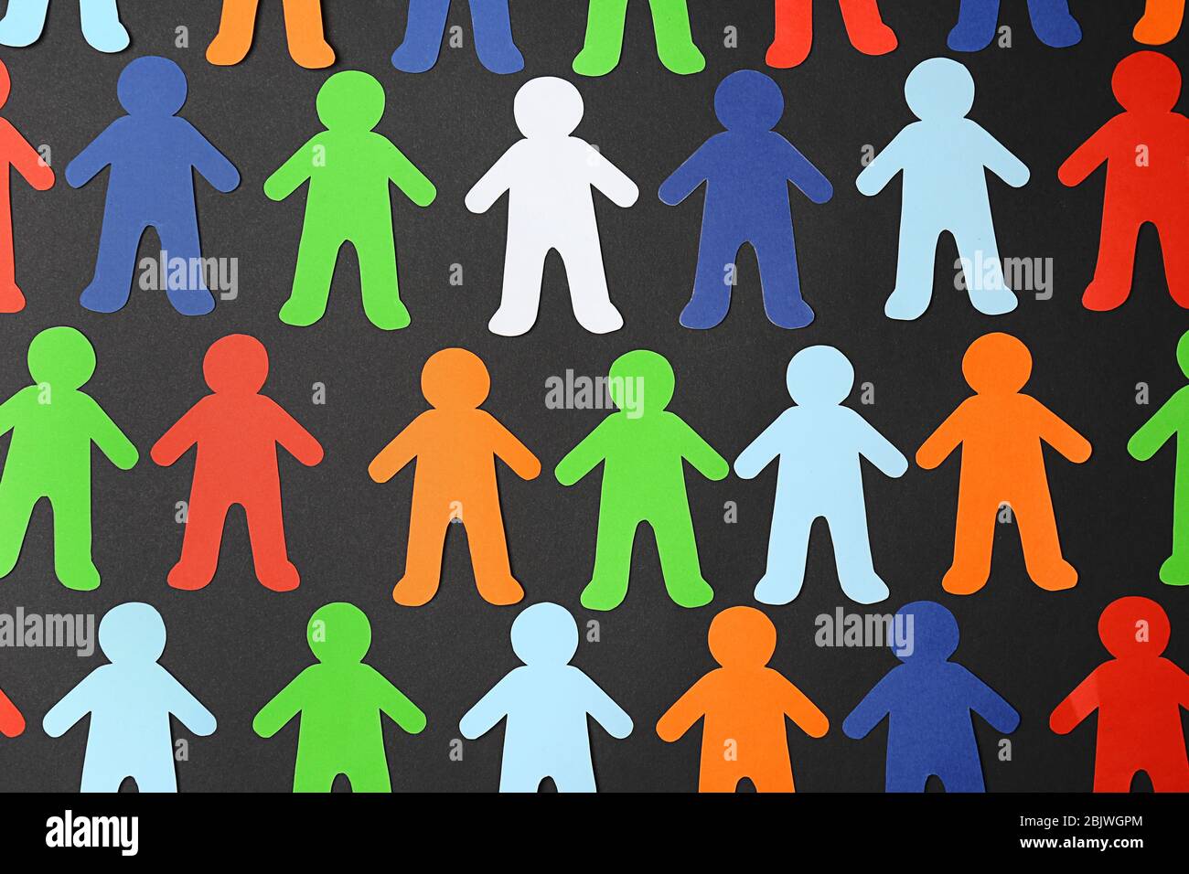 Different paper human figures on black background Stock Photo - Alamy
