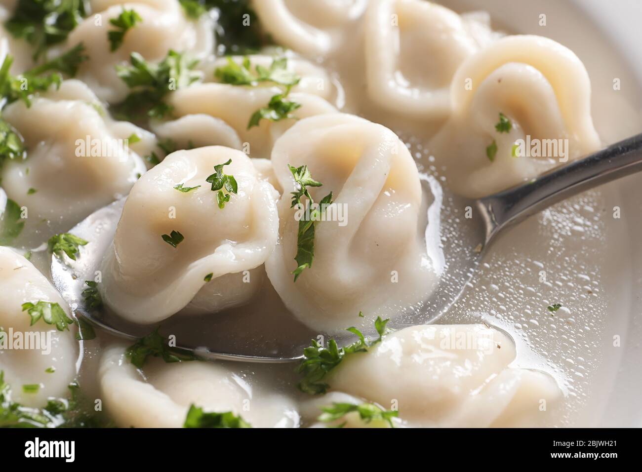 Spoon with tasty dumplings, closeup Stock Photo - Alamy