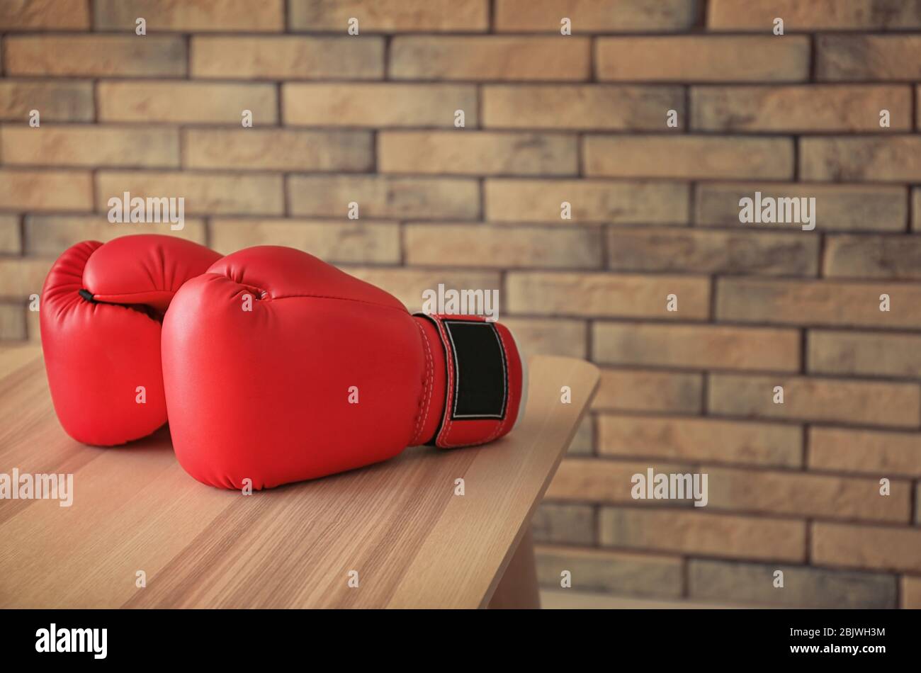 Boxing gloves on table indoors Stock Photo - Alamy