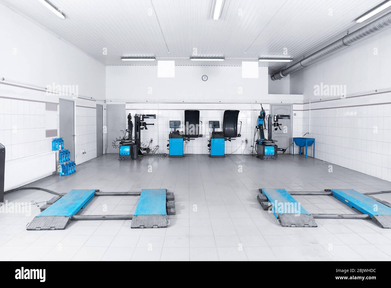 Car service center interior with tire changing station Stock Photo - Alamy