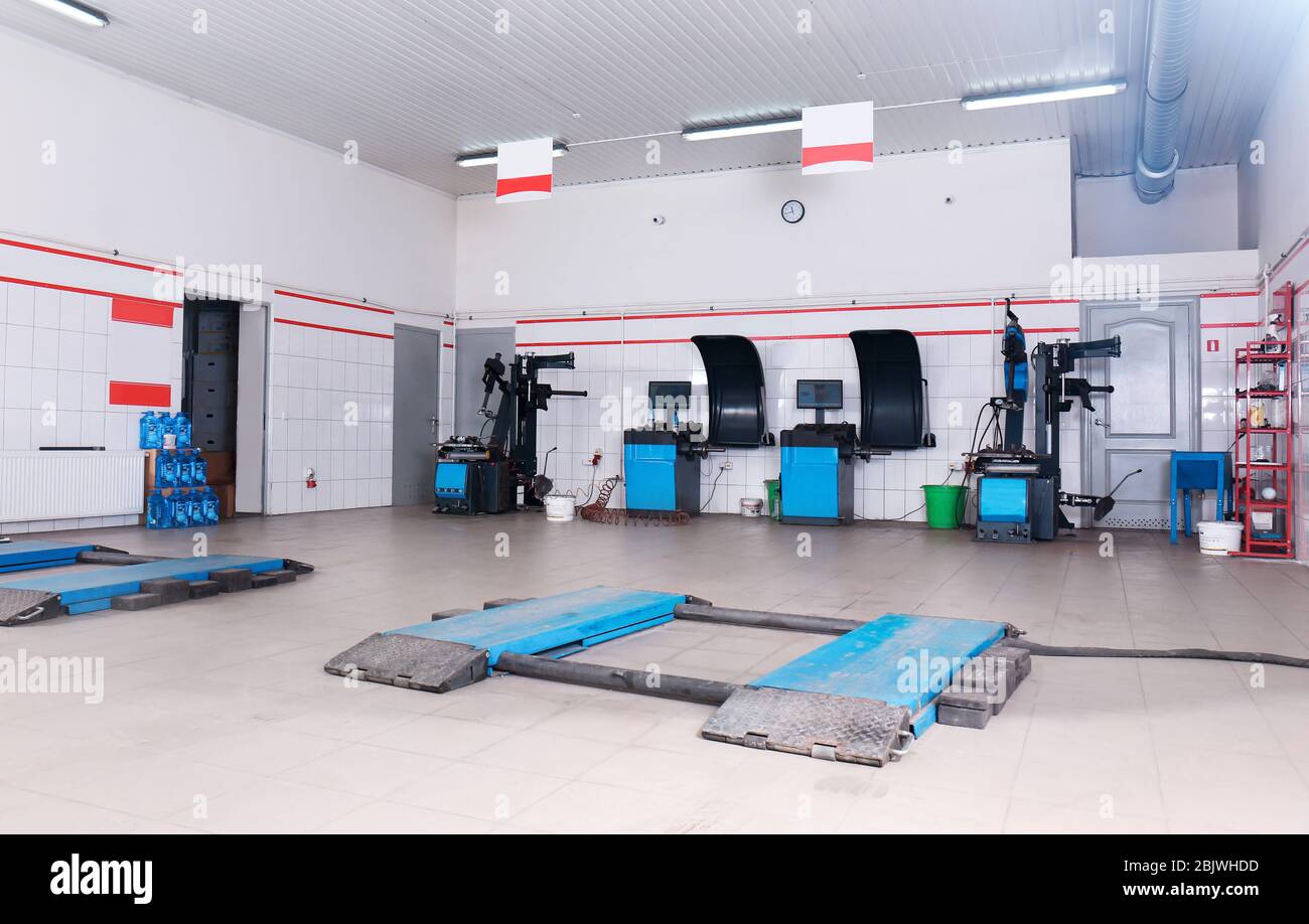 Car service center interior with tire changing station Stock Photo - Alamy