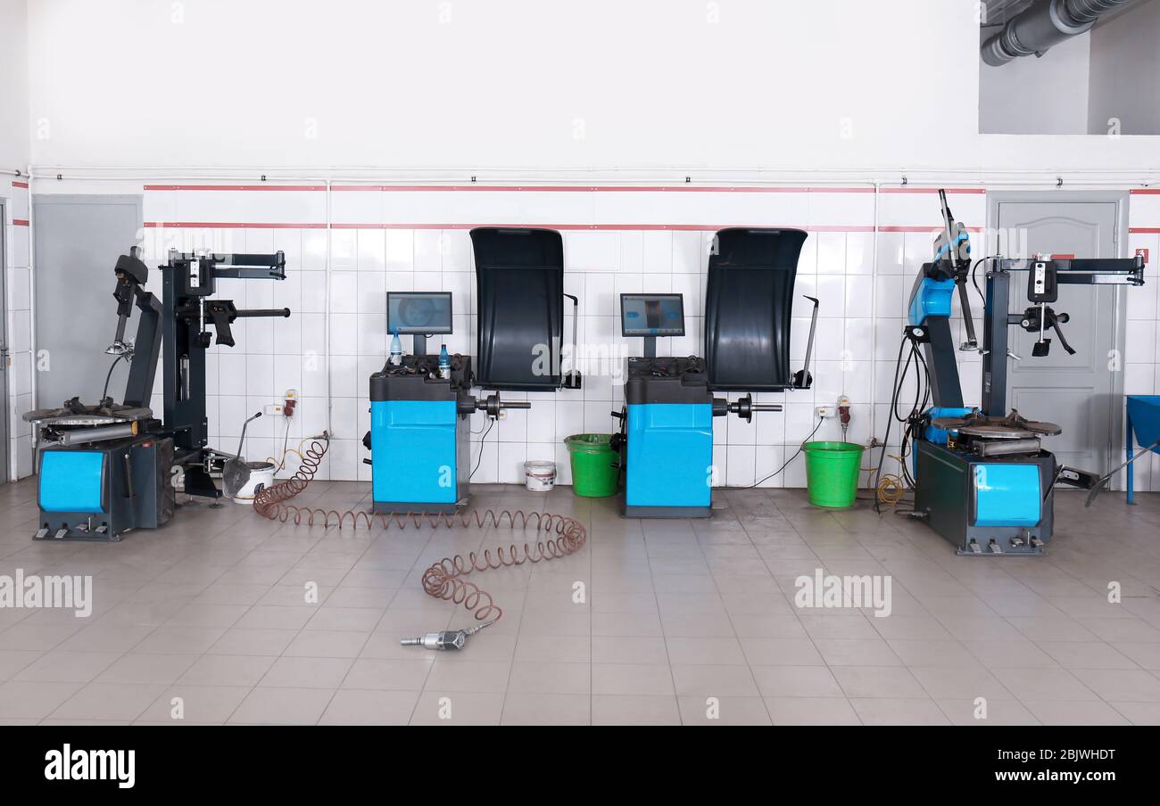 Car service center interior with modern tire fitting and wheel ...