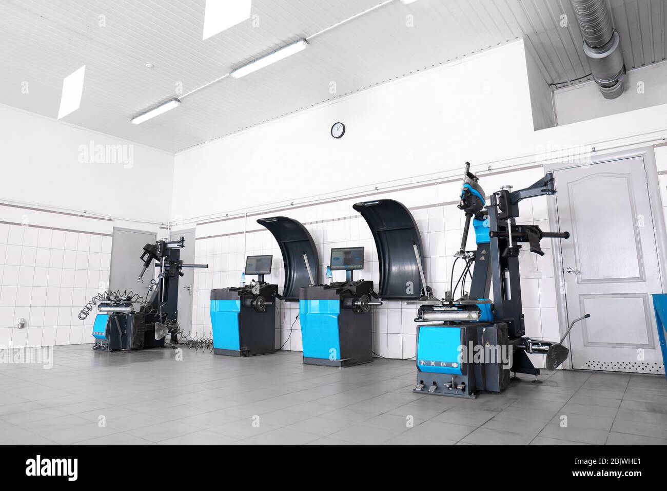 Car service center interior with modern tire fitting and wheel ...