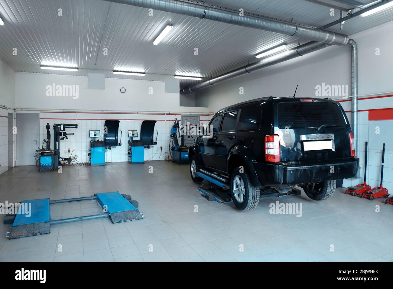 Auto service center interior with car and tire changing station Stock ...
