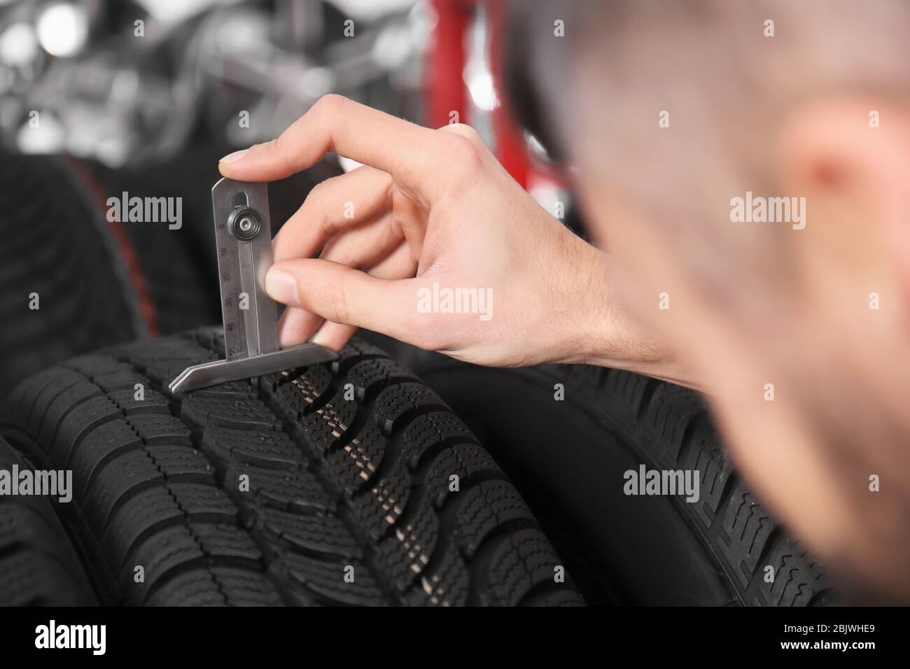 Mechanic measuring tire tread hi-res stock photography and images - Alamy