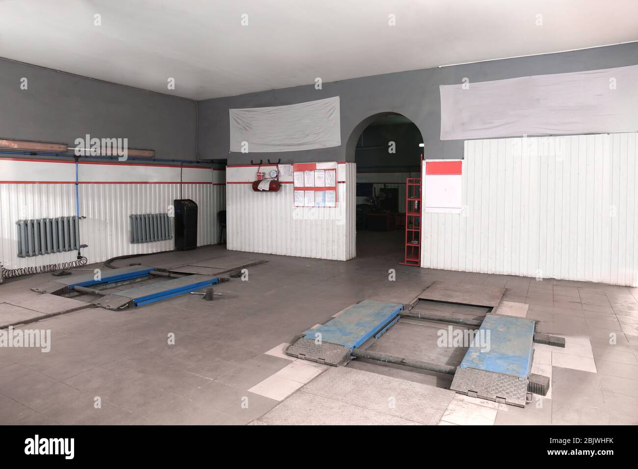 Car service center interior with tire changing station Stock Photo - Alamy