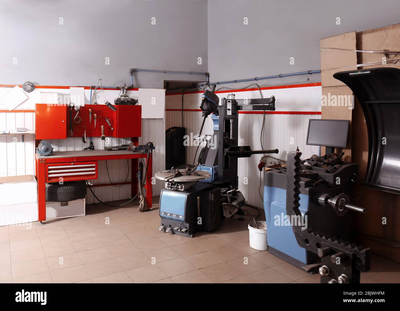 Car service center interior with modern tire fitting and wheel ...
