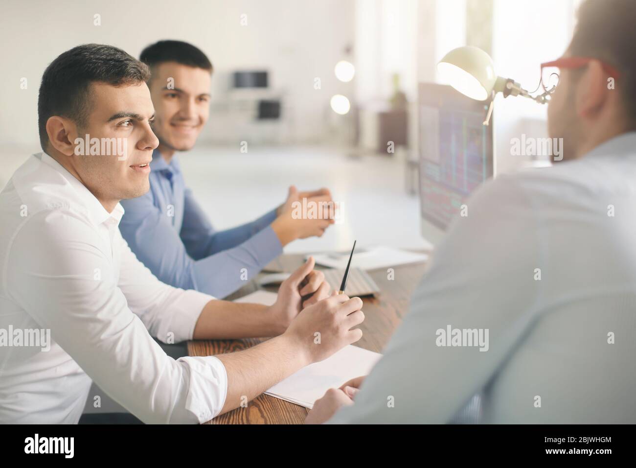 Young men working in office Stock Photo - Alamy