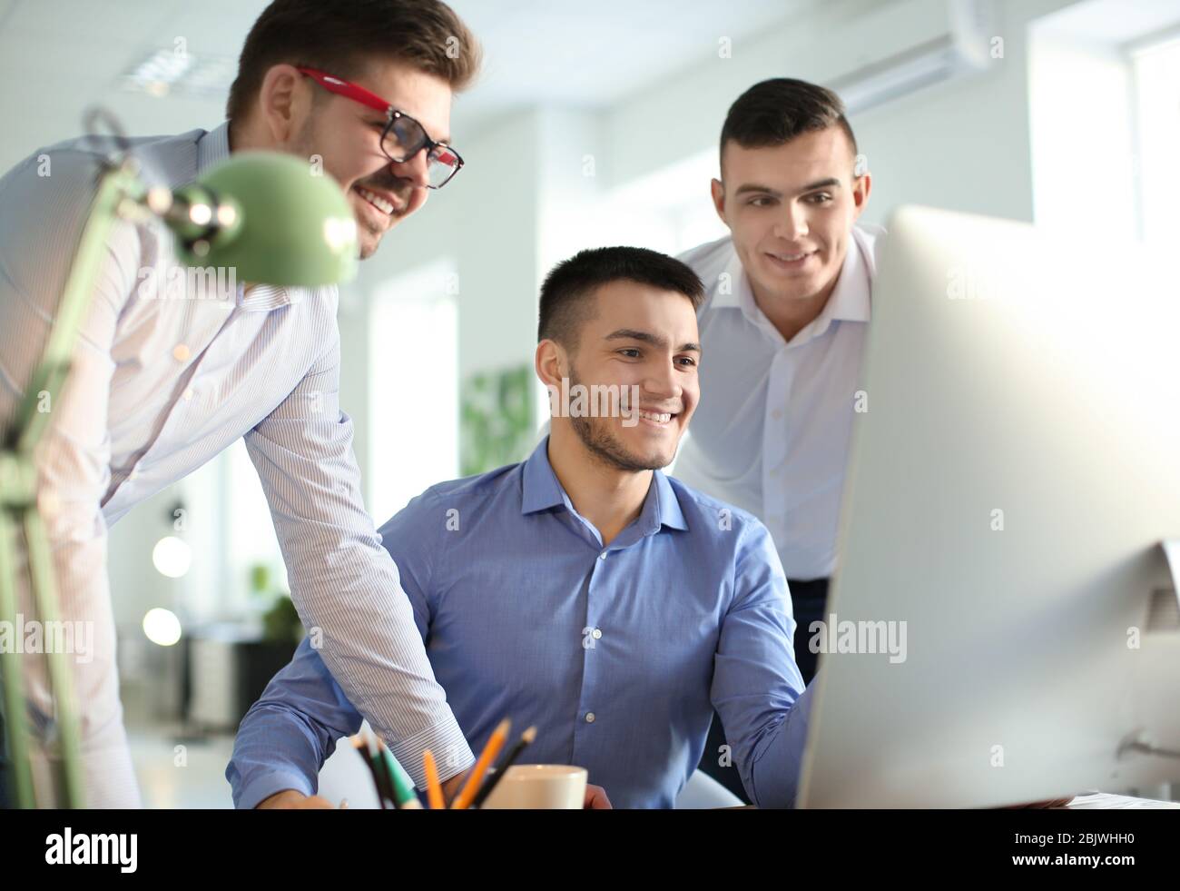 Young men working in office Stock Photo - Alamy