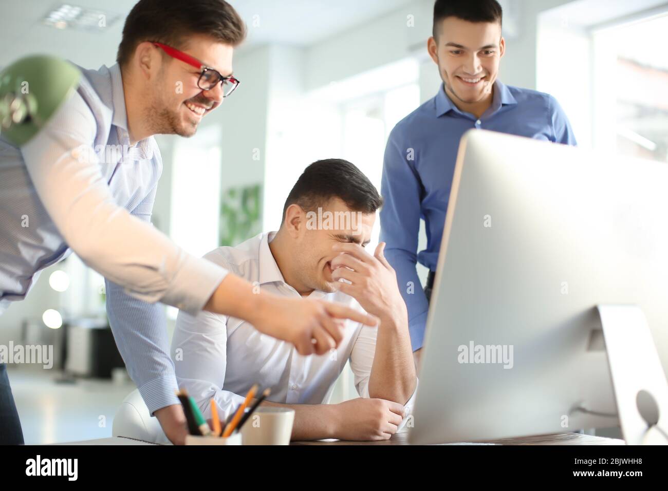 Young men working in office Stock Photo - Alamy