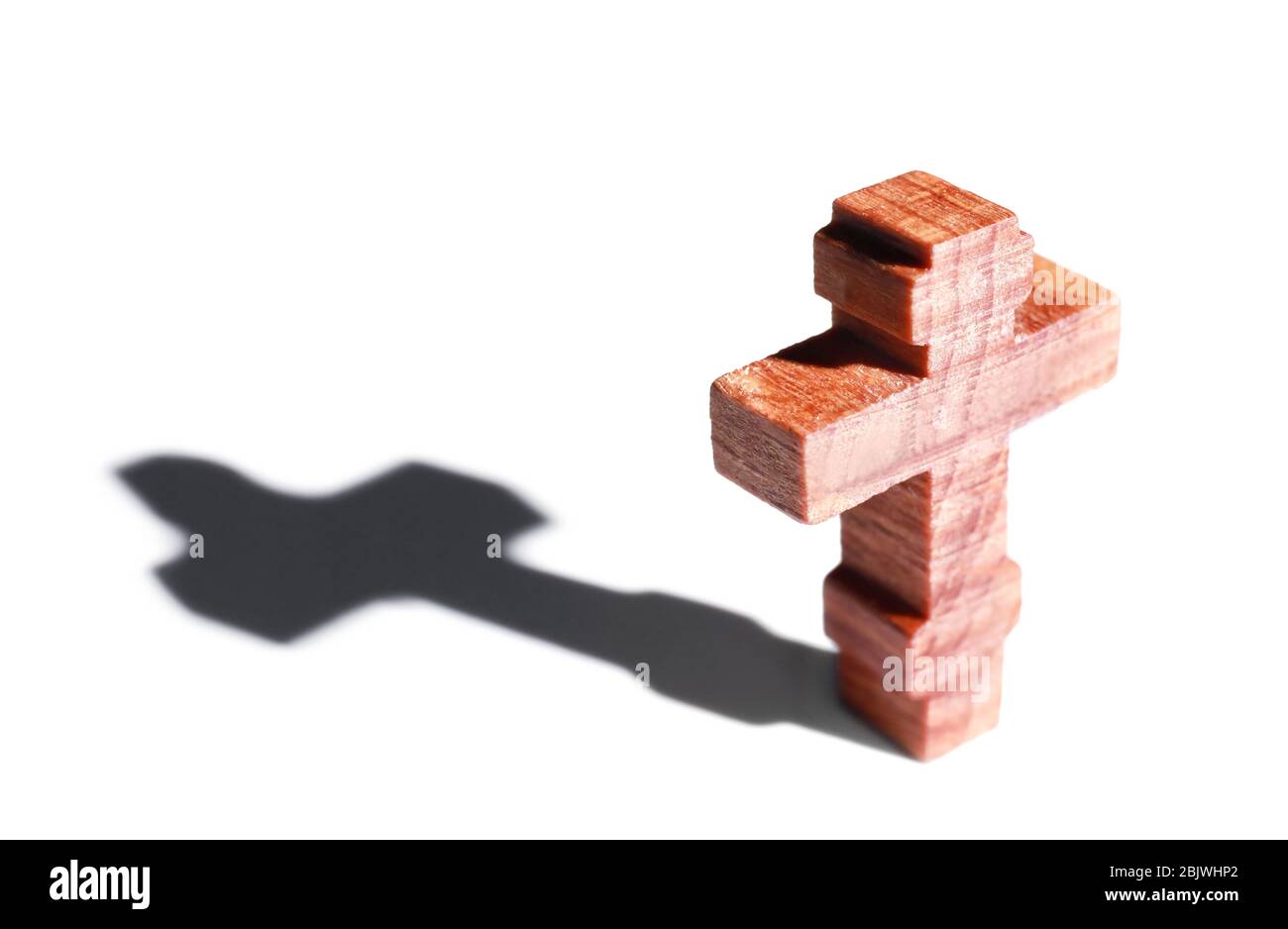 Wooden cross with shadow on white background Stock Photo - Alamy