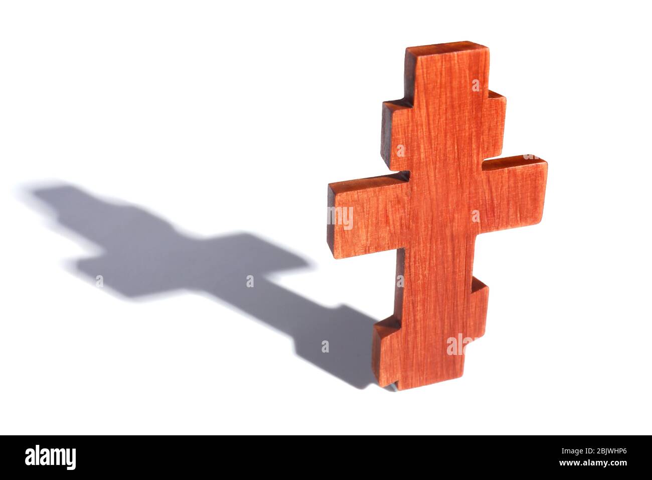 Wooden cross with shadow on white background Stock Photo - Alamy