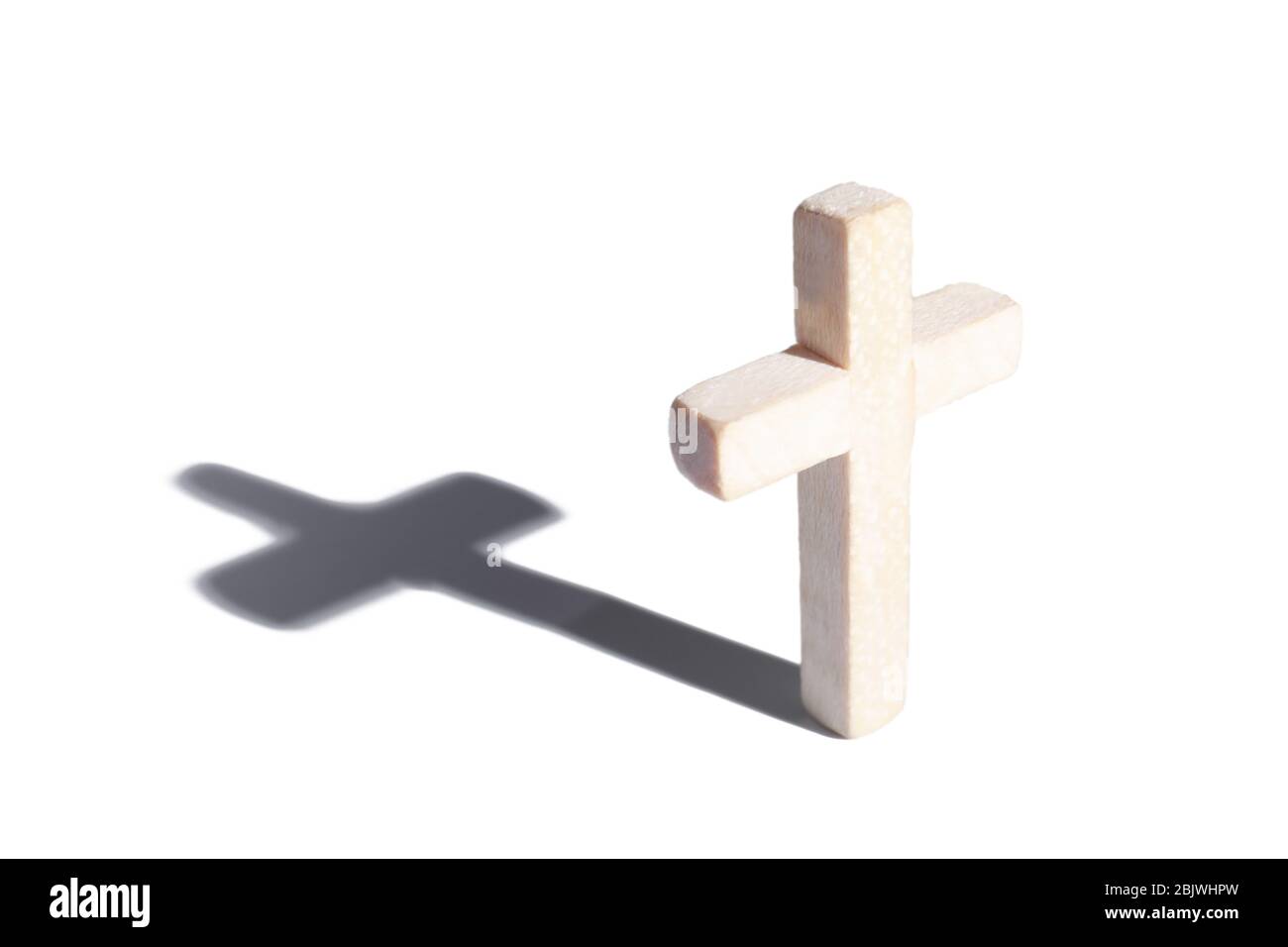 Wooden cross with shadow on white background Stock Photo - Alamy