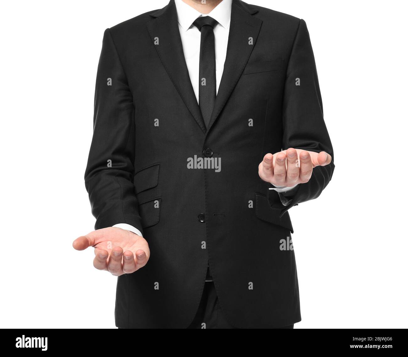 Young businessman showing balance gesture on white background Stock ...