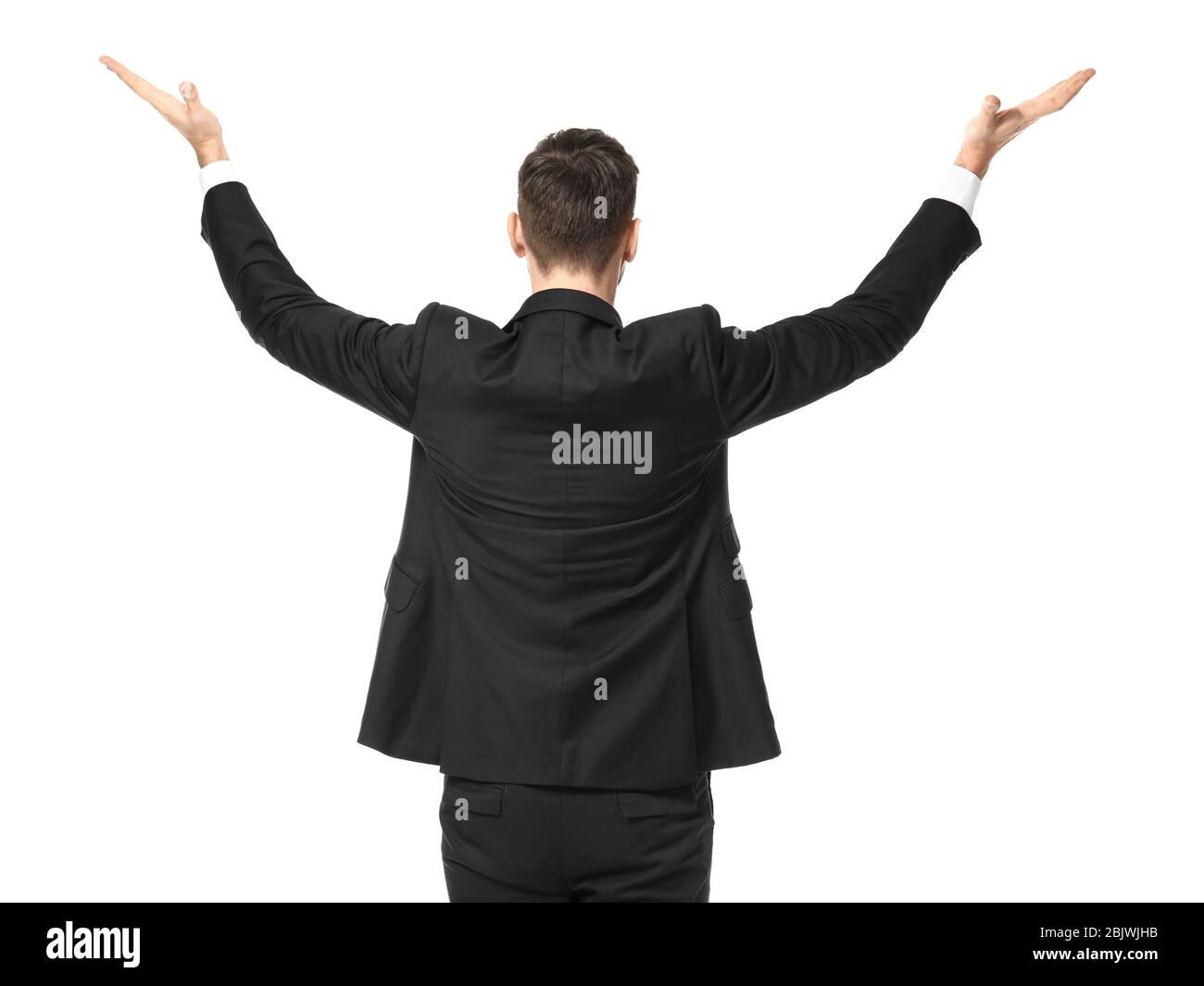 Young businessman showing balance gesture on white background Stock ...