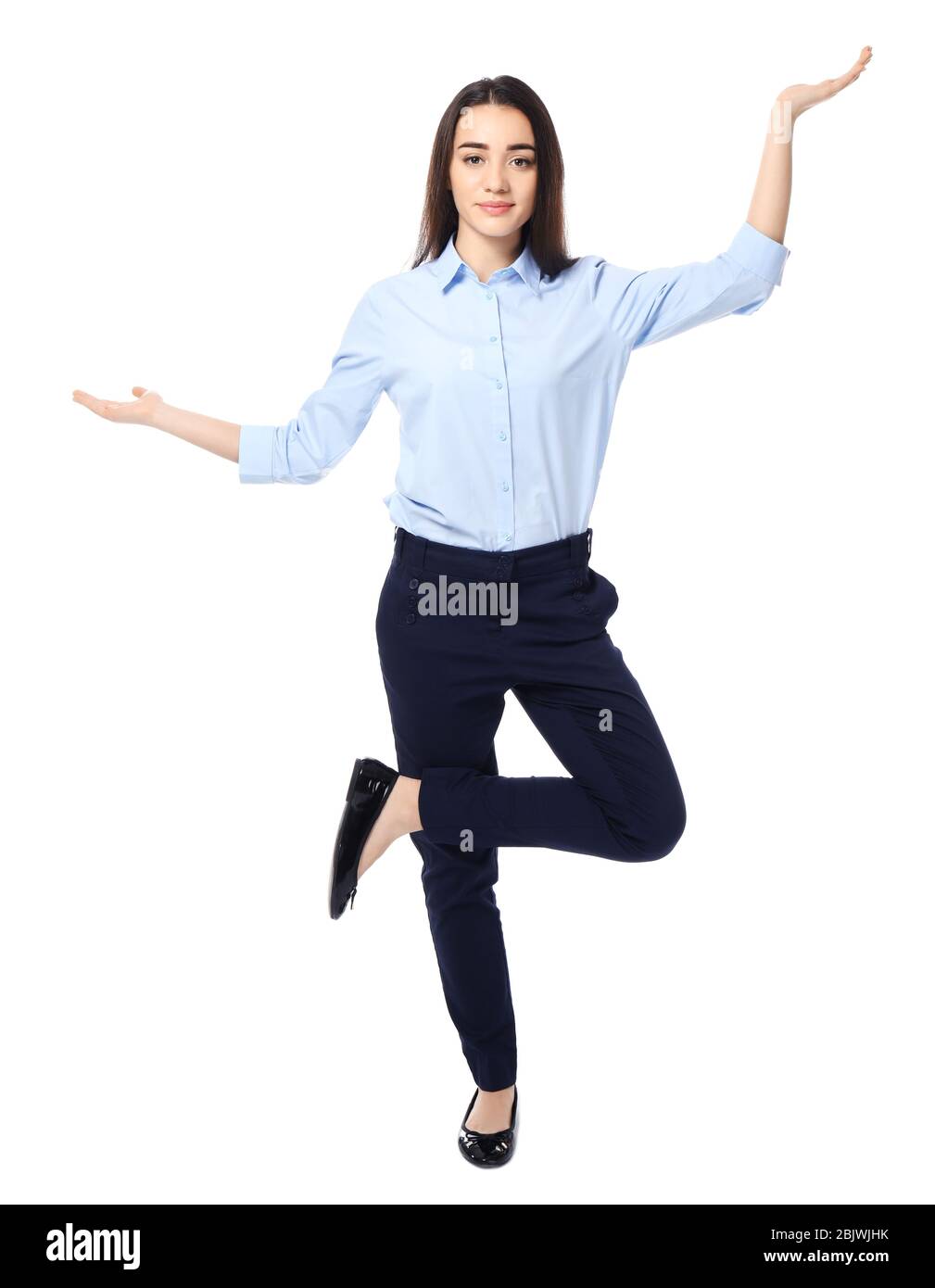 Young businesswoman showing balance gesture on white background Stock ...