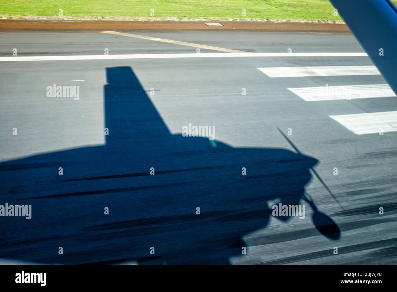 Commuter plane shadow taking off at Kona International Airport, Hawaii ...
