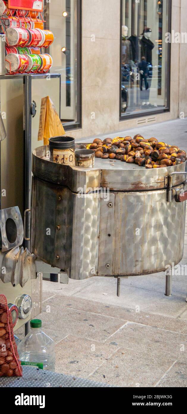 Hot chestnuts roasting on a grill in the city of Milan, Italy Stock ...