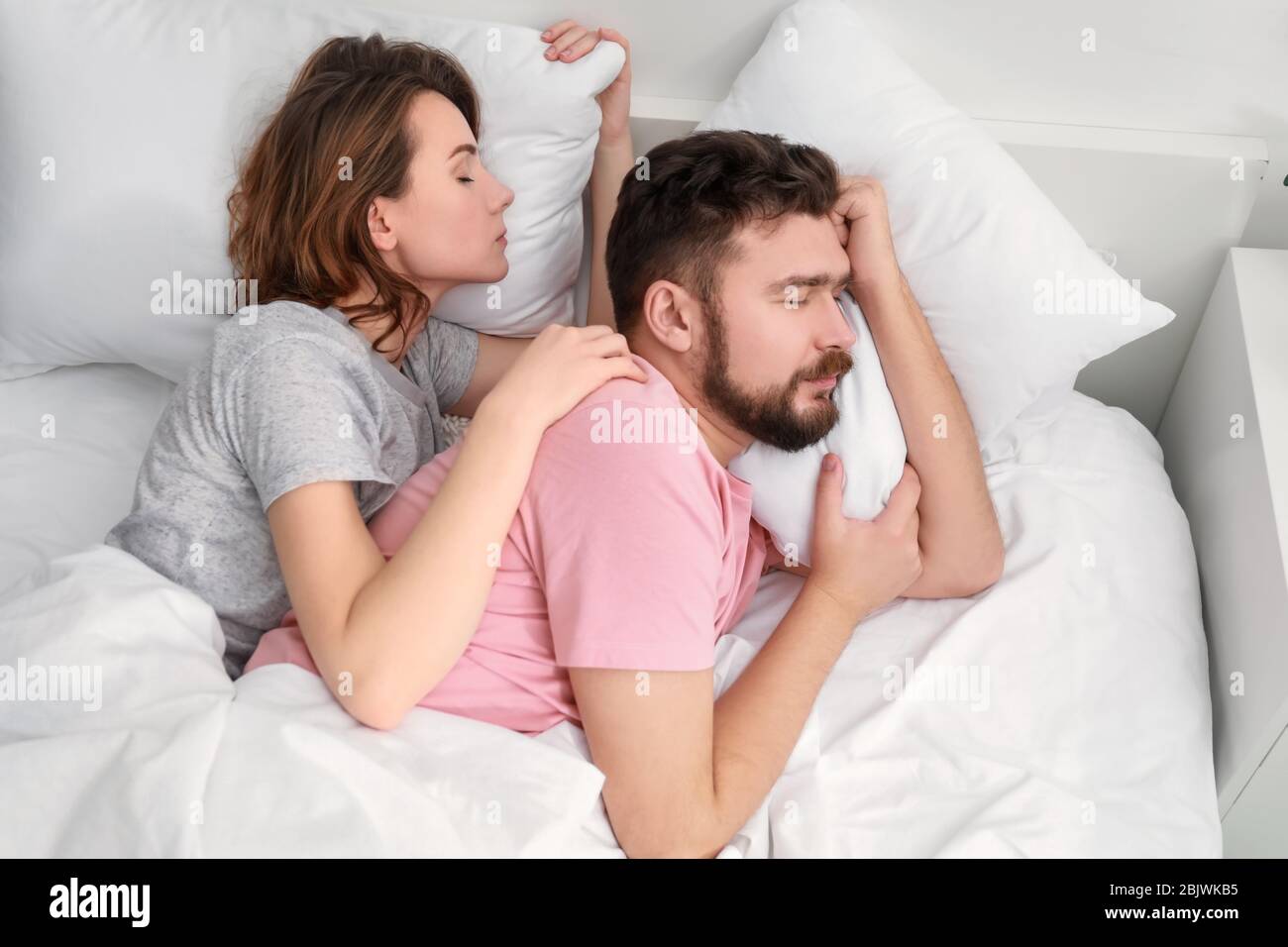 Husband and wife sleeping in bed at home Stock Photo - Alamy