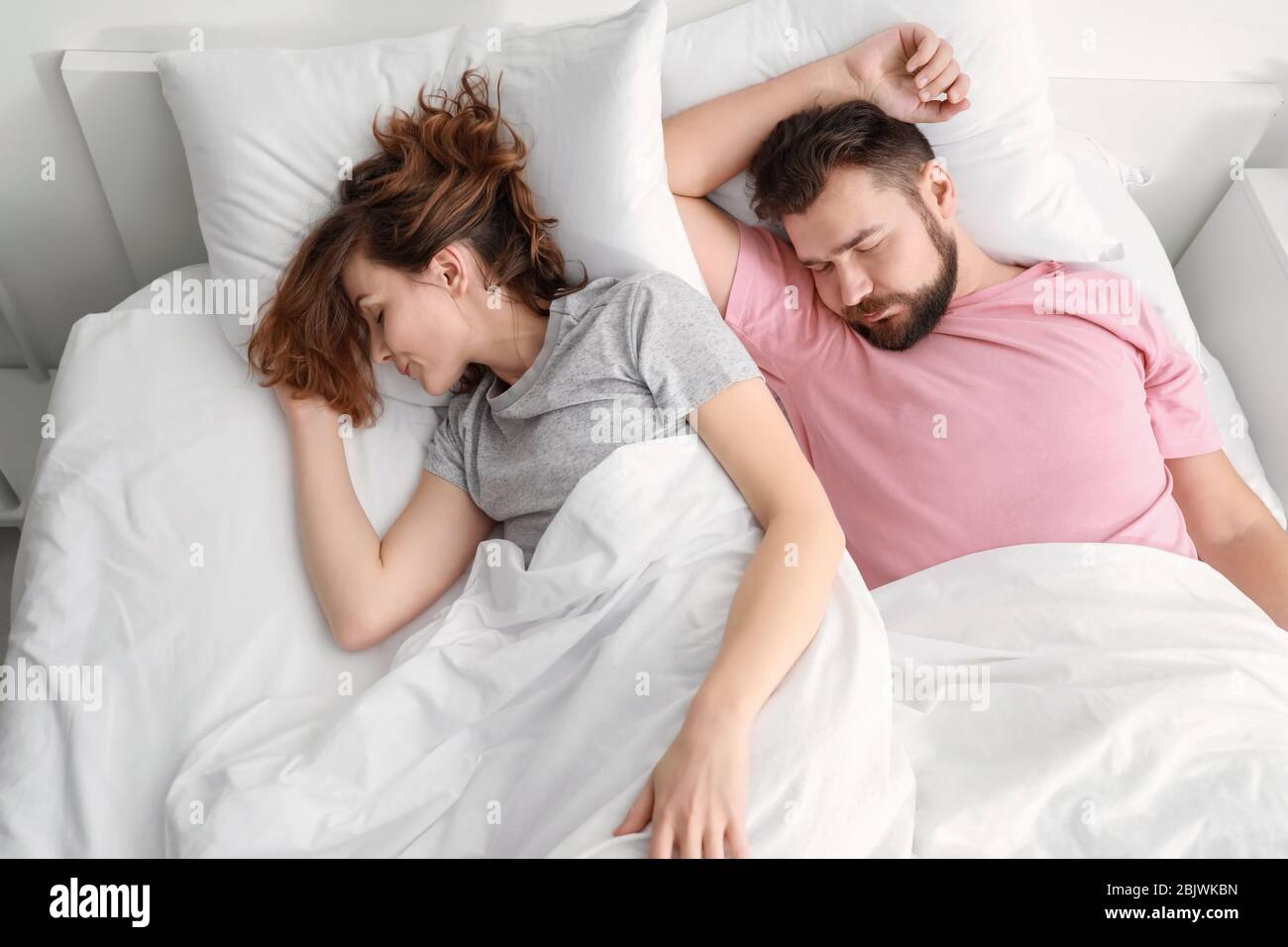 Husband and wife sleeping in bed at home Stock Photo - Alamy