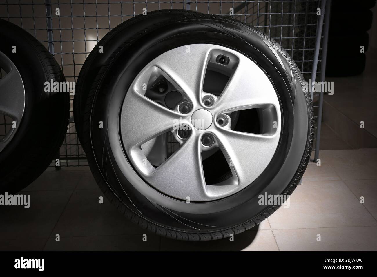 Car tire with rim indoors Stock Photo - Alamy