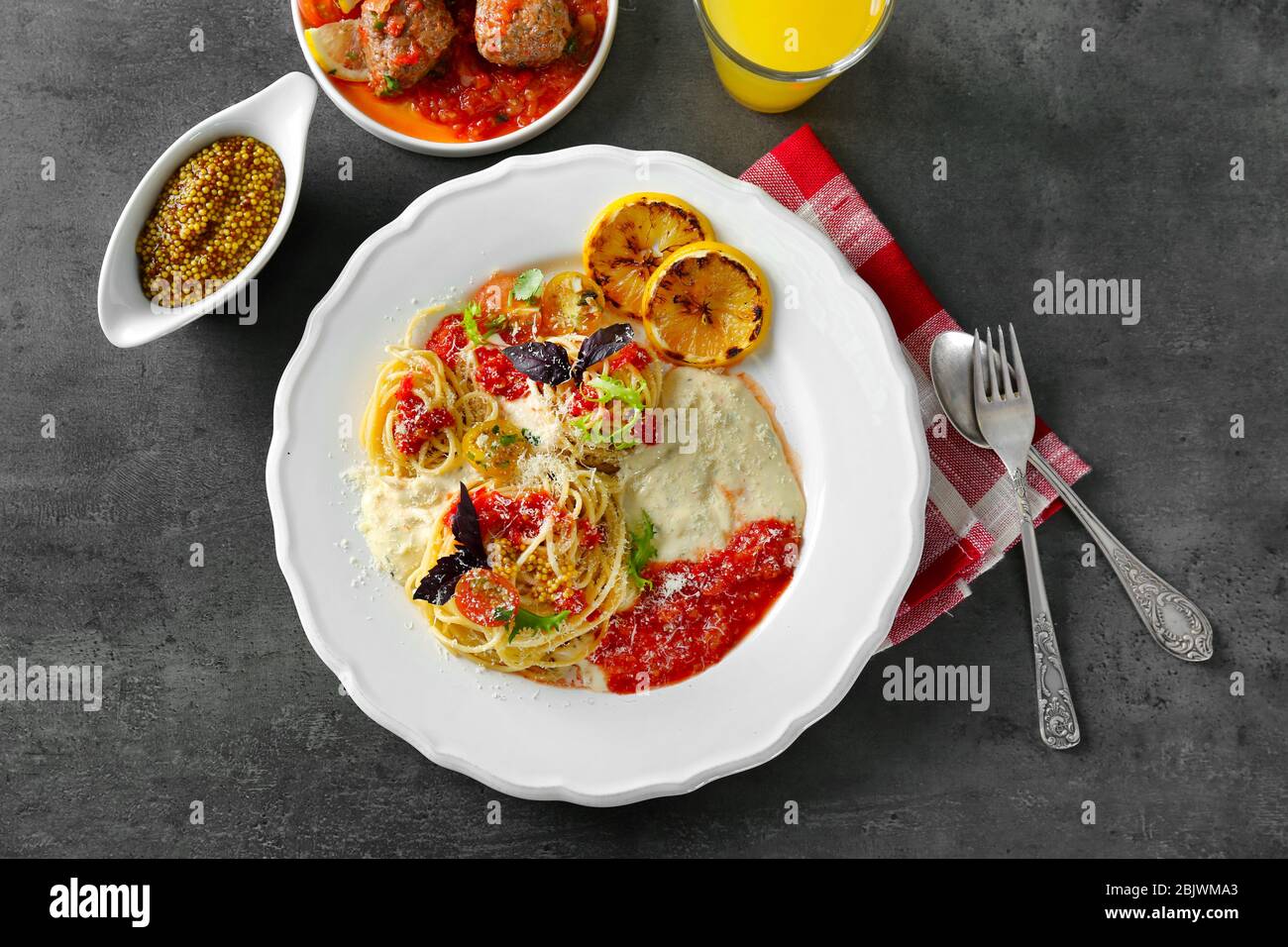 Delicious pasta with tomato sauce and vegetables on plate Stock Photo ...