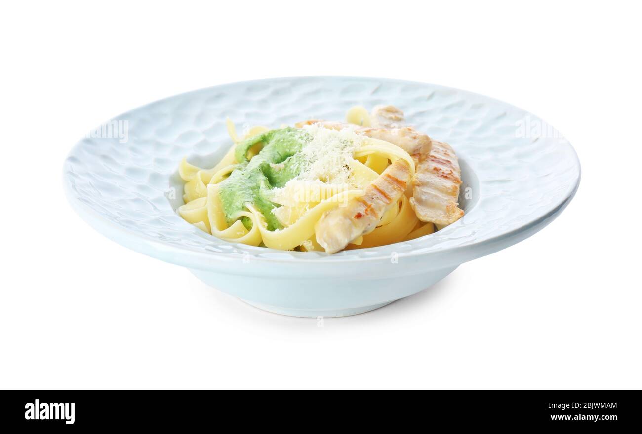 Delicious pasta with chicken on plate against white background Stock ...