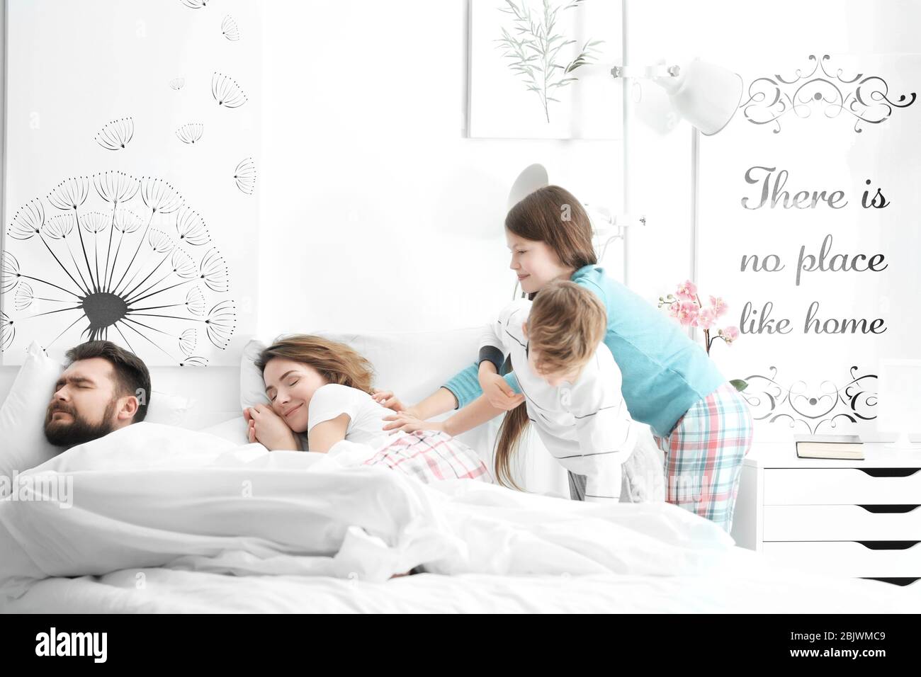 Children waking up their parents in bedroom Stock Photo - Alamy