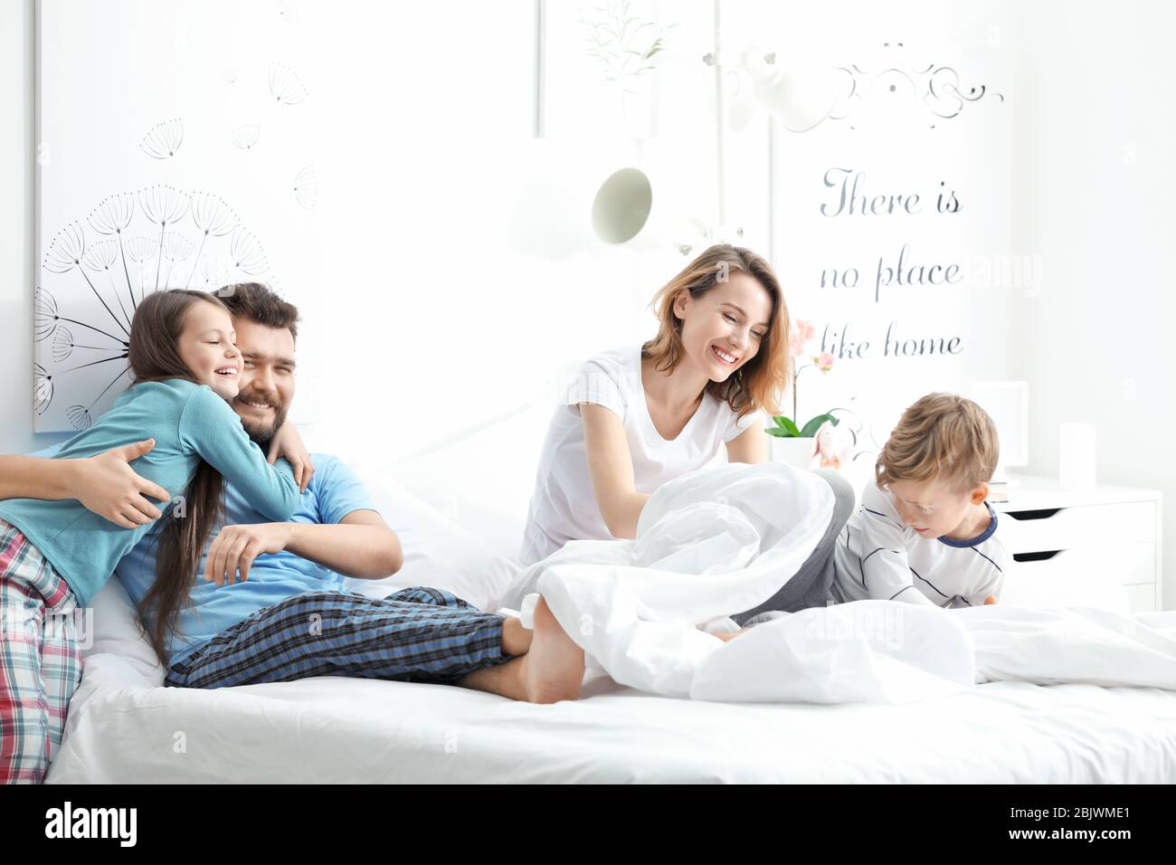 Beautiful morning of happy family in bedroom Stock Photo - Alamy