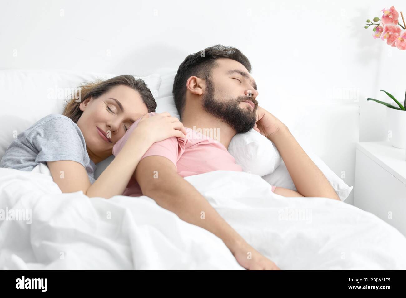 Husband and wife sleeping in bed at home Stock Photo - Alamy