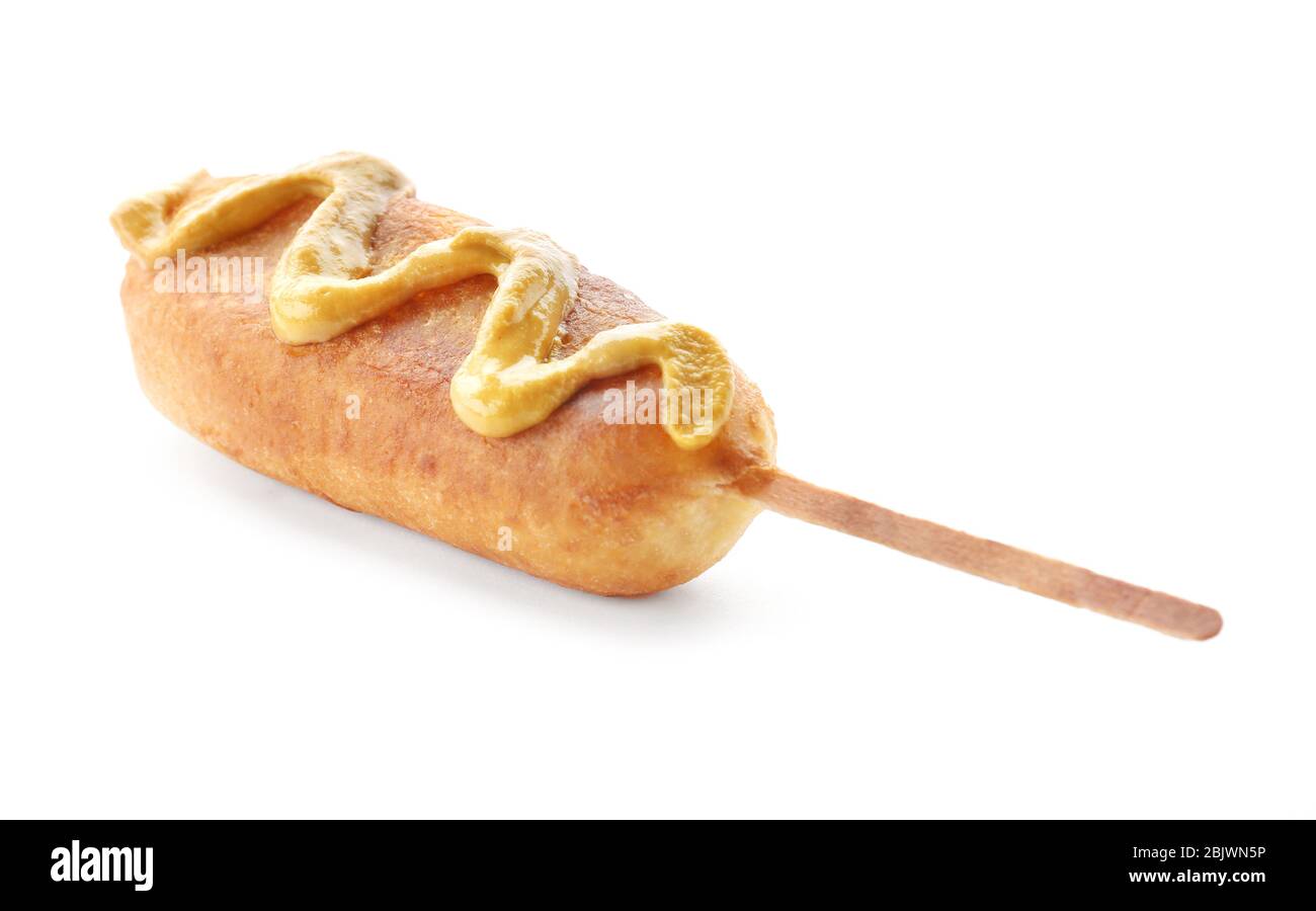 Tasty corn dog with mustard on white background Stock Photo - Alamy