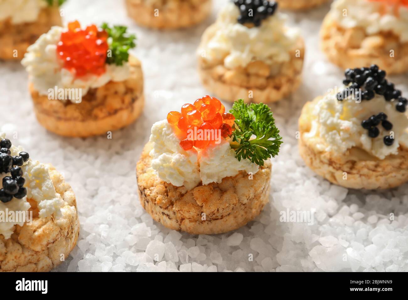 Delicious canapes with black and red caviar on sea salt Stock Photo - Alamy