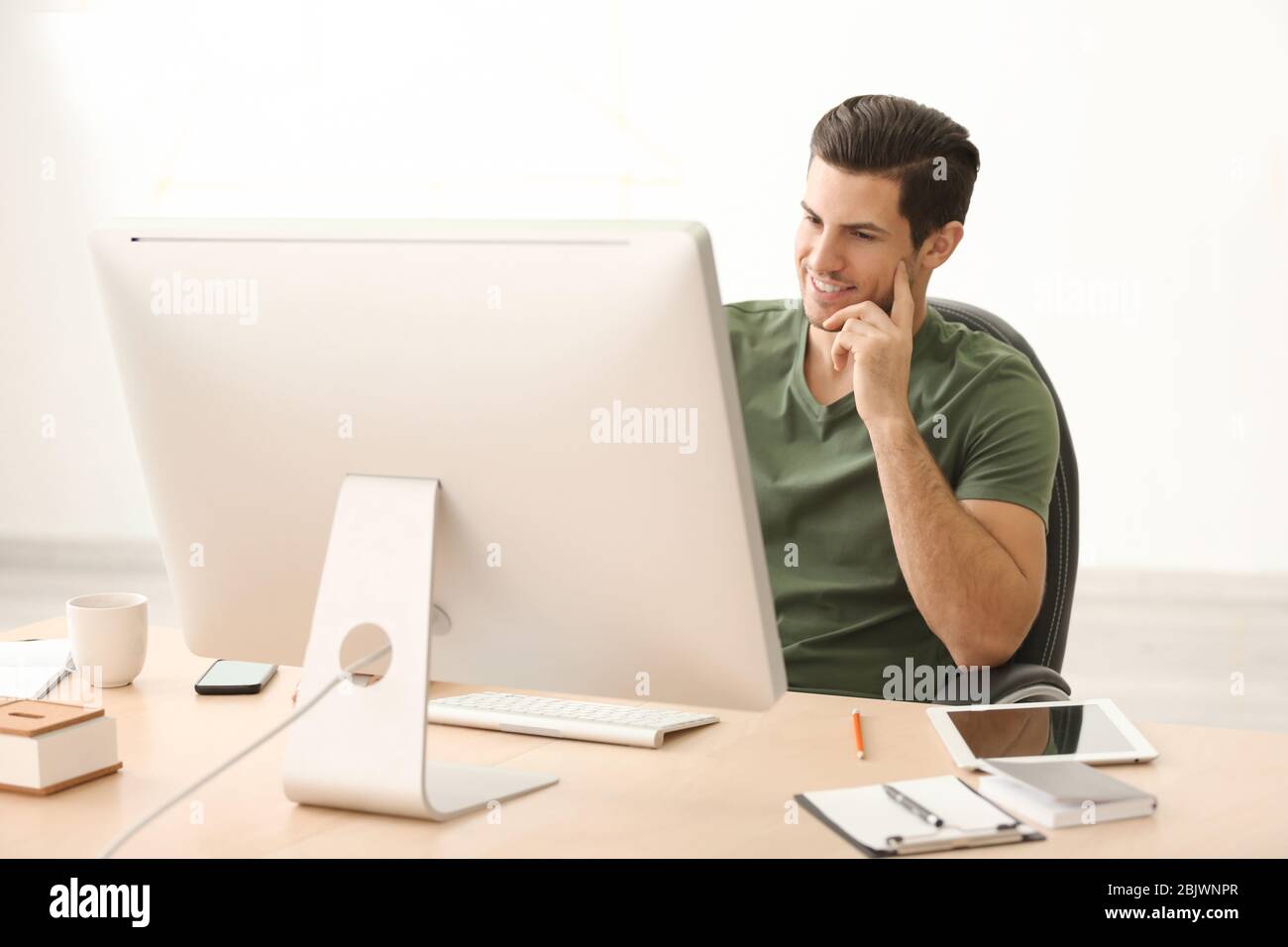 Young man working with computer in office Stock Photo - Alamy