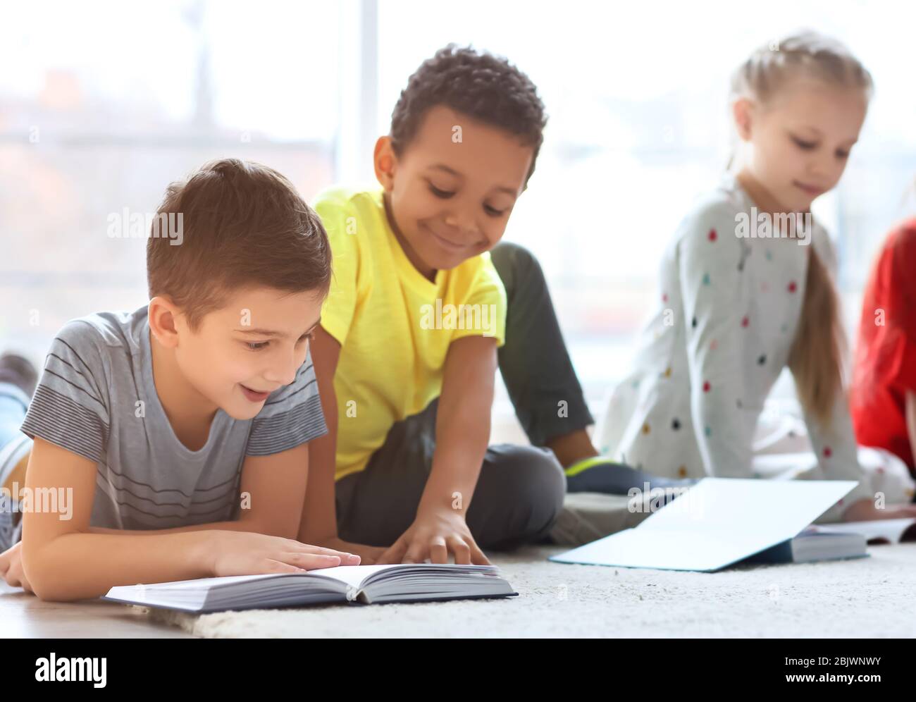 Cute children doing homework in classroom at school Stock Photo - Alamy
