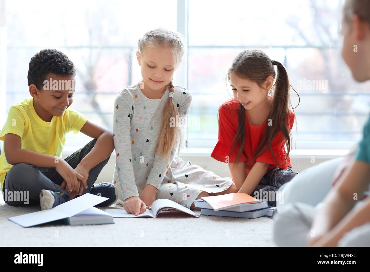 Cute children doing homework in classroom at school Stock Photo - Alamy
