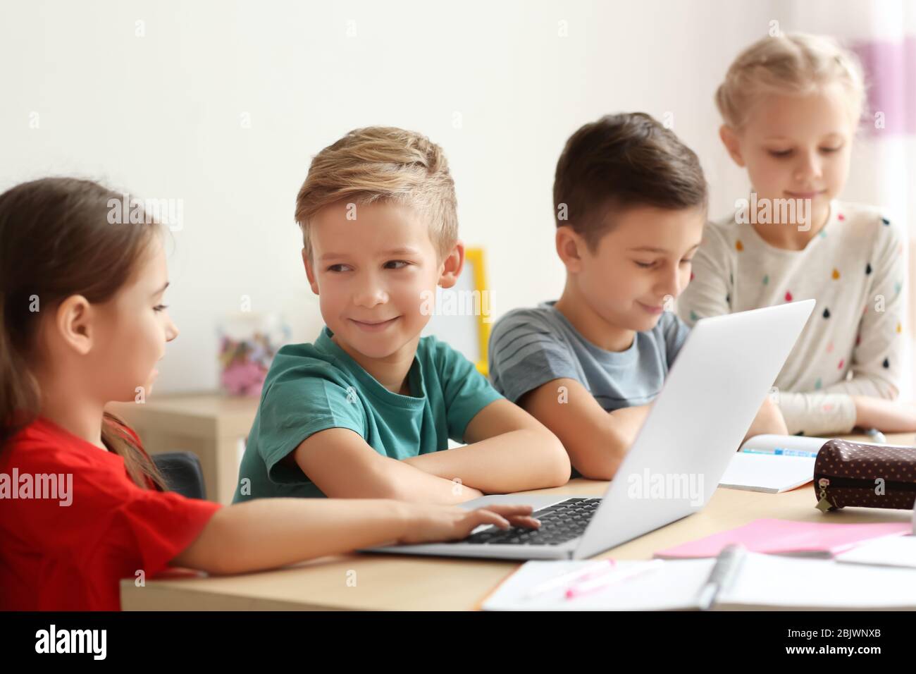 Cute children doing homework in classroom at school Stock Photo - Alamy