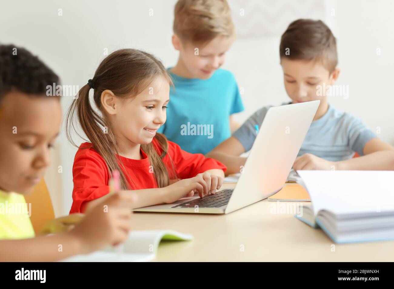 Cute children doing homework in classroom at school Stock Photo - Alamy