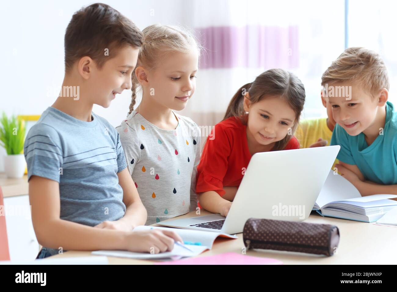 Cute children doing homework in classroom at school Stock Photo - Alamy