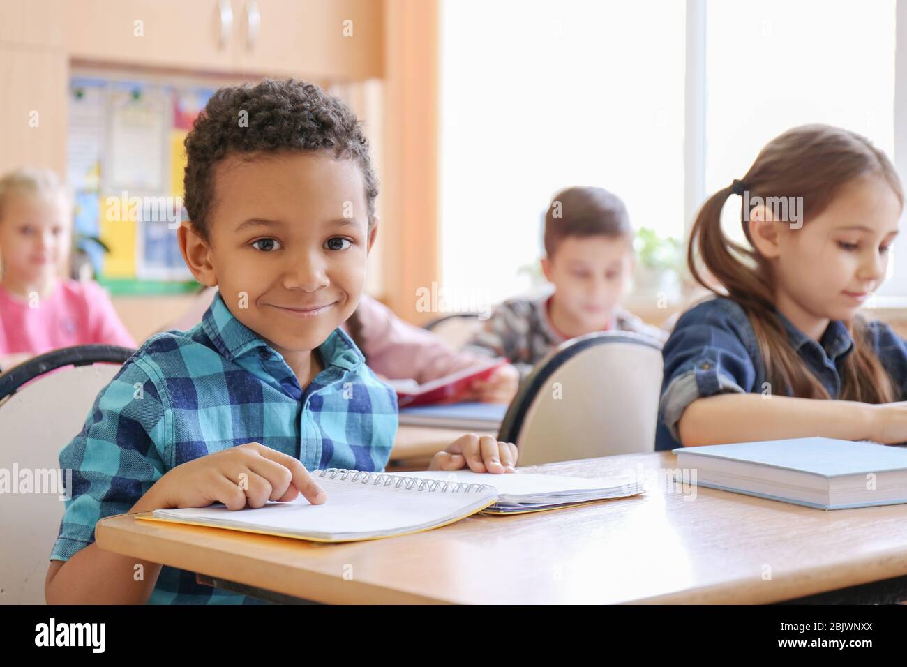 Cute children doing homework in classroom at school Stock Photo - Alamy