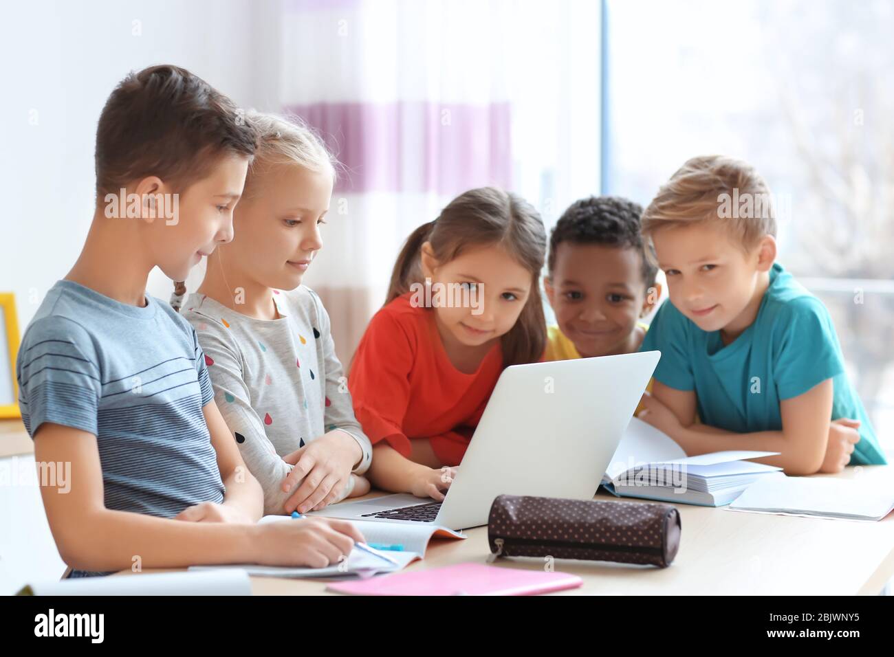 Cute children doing homework in classroom at school Stock Photo - Alamy