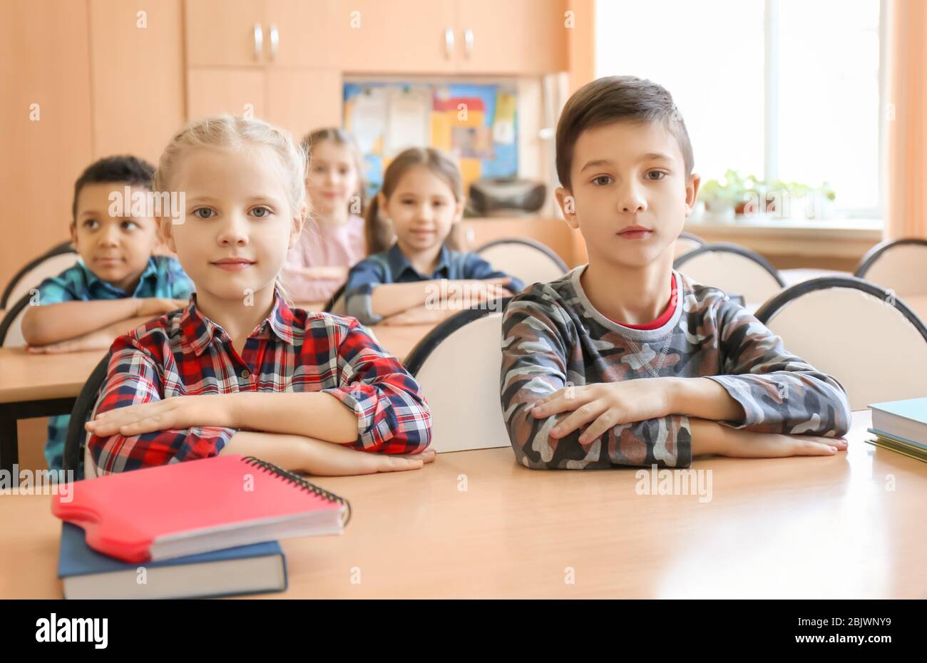 Cute children sitting in classroom at school Stock Photo - Alamy