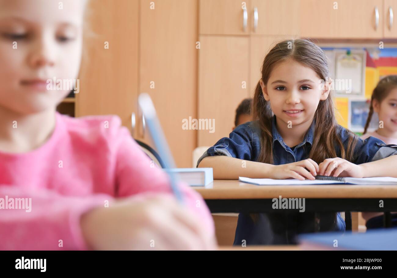 Cute children doing homework in classroom at school Stock Photo - Alamy