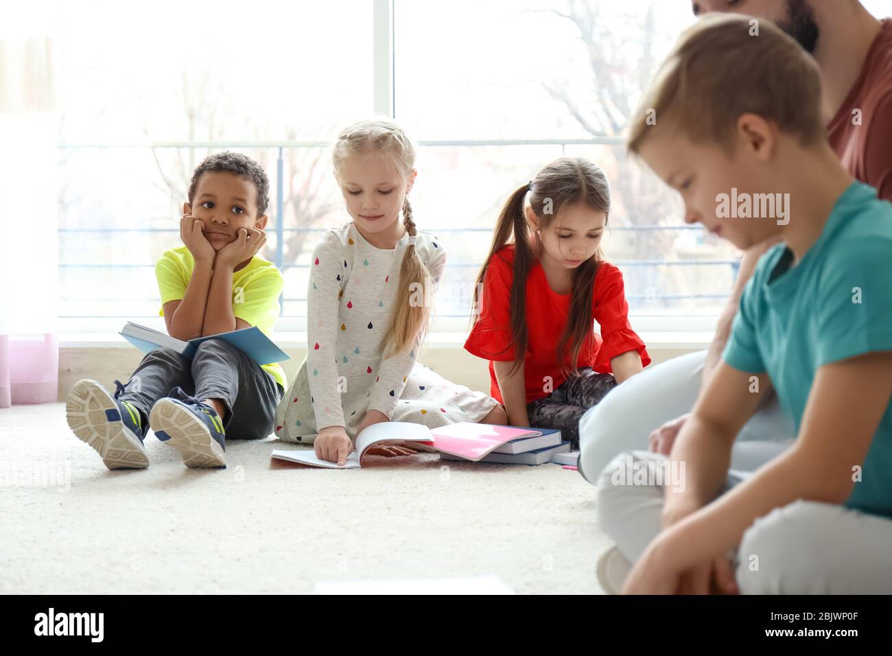 Cute children doing homework in classroom at school Stock Photo - Alamy