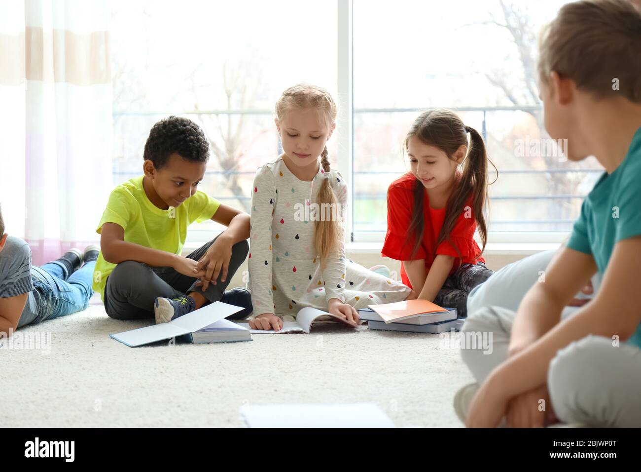 Cute children doing homework in classroom at school Stock Photo - Alamy