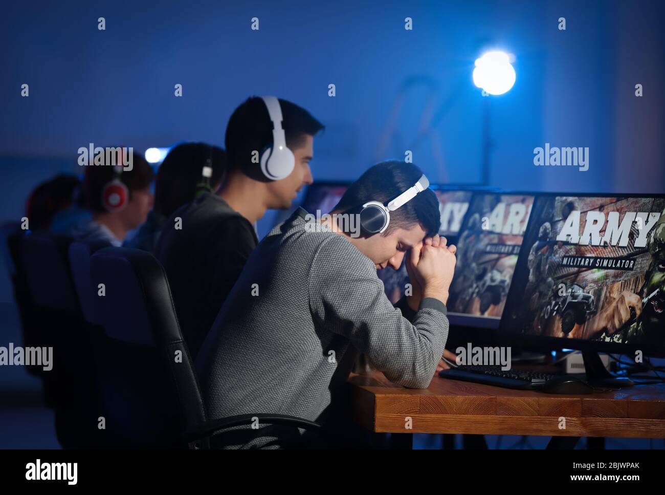 Young people playing video games at tournament Stock Photo - Alamy